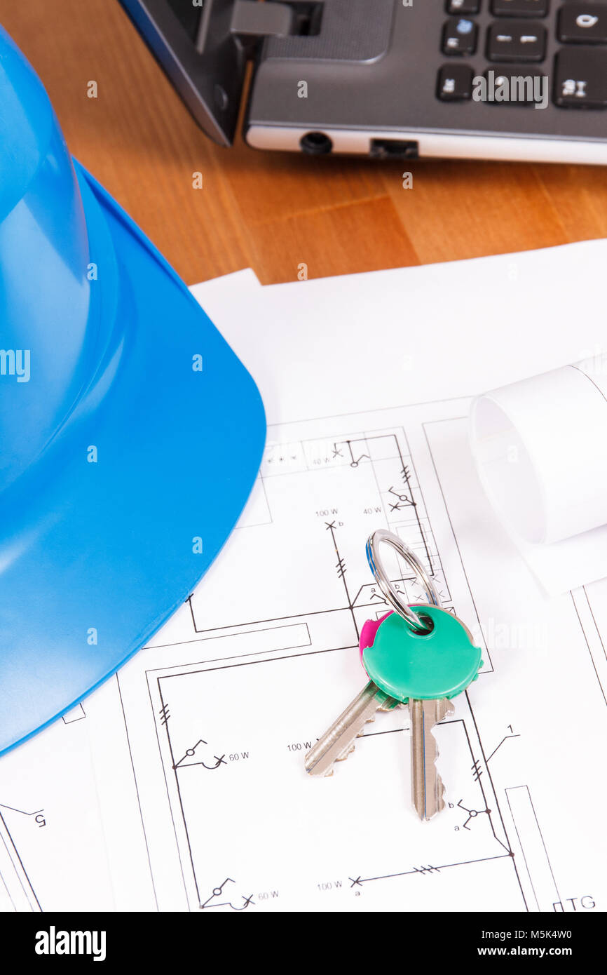 Home keys, diagrams or electrical construction drawings with laptop and ...
