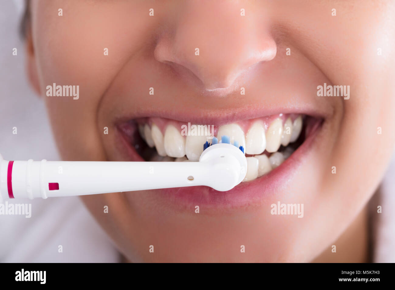 Close-up Of A Woman Brushing Teeth Using Electric Toothbrush Stock ...