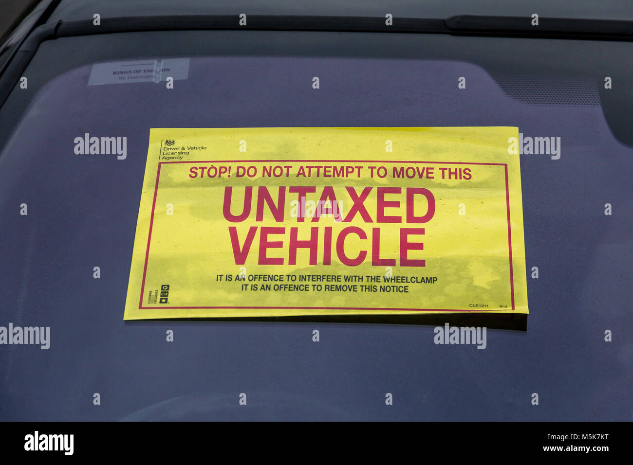 Warning sticker attached to a vehicle penalised for unpaid vehicle tax ...