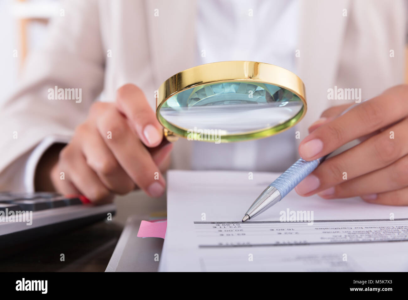 Close-up Of Businesswoman Checking Invoice With Magnifying Glass At ...