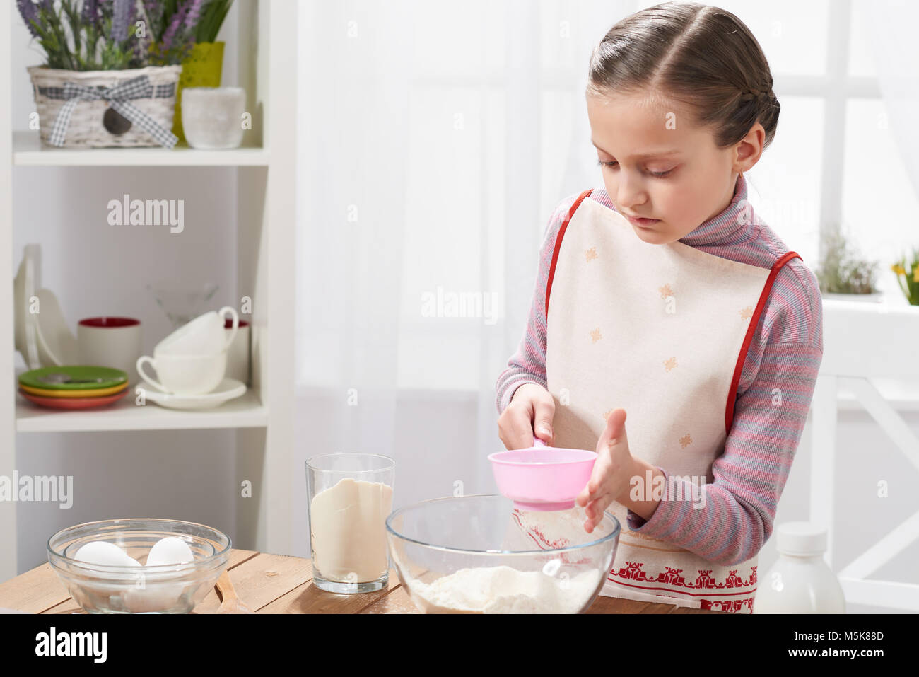 Girl cooking in home kitchen, making pastries, healthy food concept ...