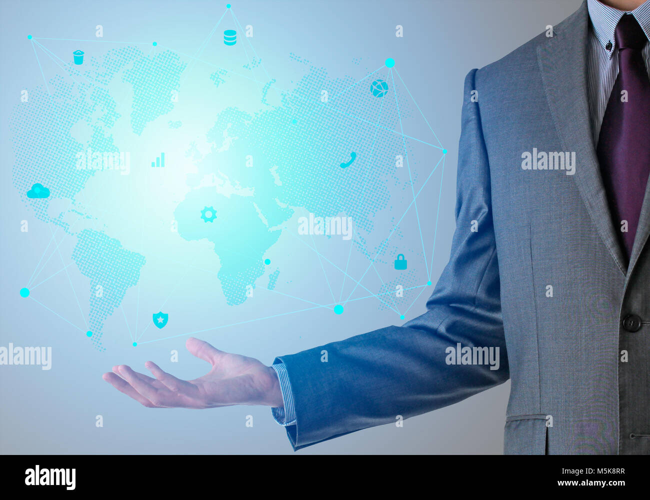 Businessman in suit with world map and icons in blue color Stock Photo ...