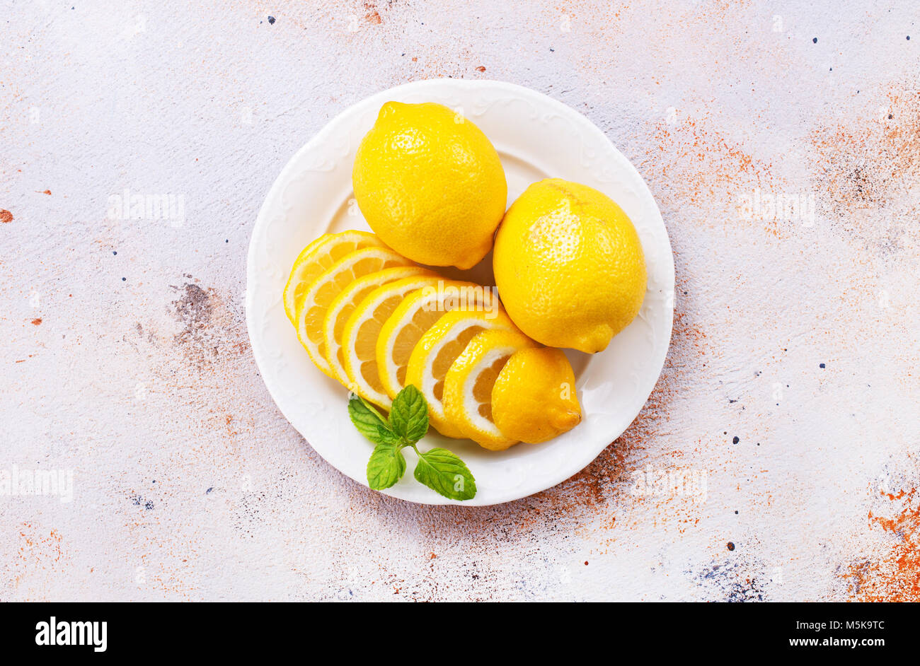 Fresh lemons and lemon slice on metal plate Stock Photo - Alamy