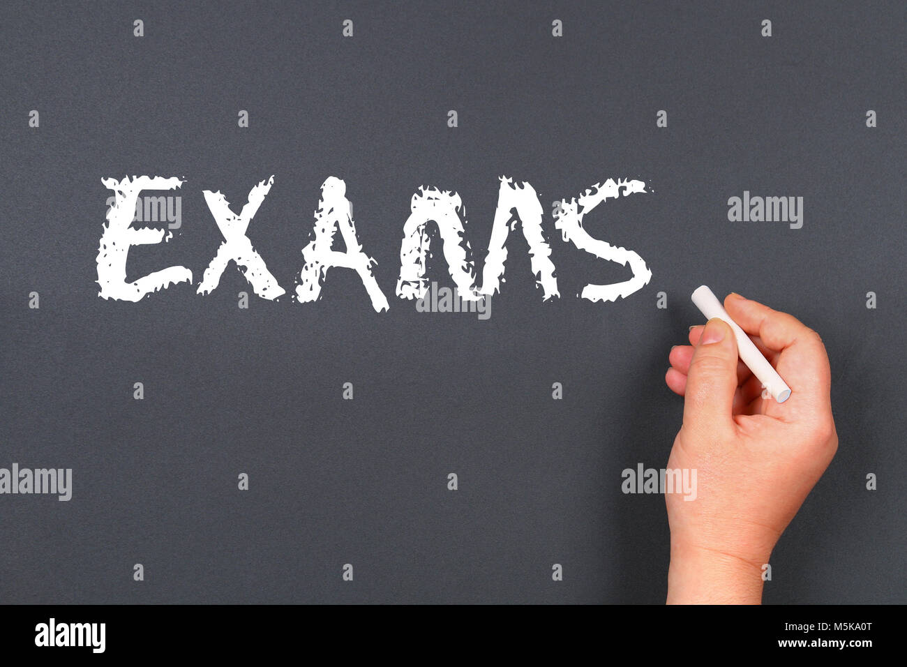 Hand writing chalk on a blackboard text: exams Stock Photo - Alamy