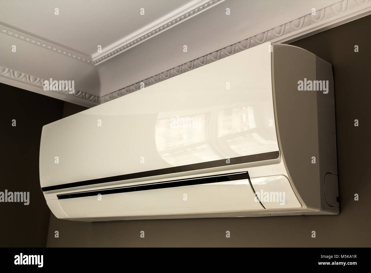 Cool air conditioner system on dark wall in room interior Stock Photo ...