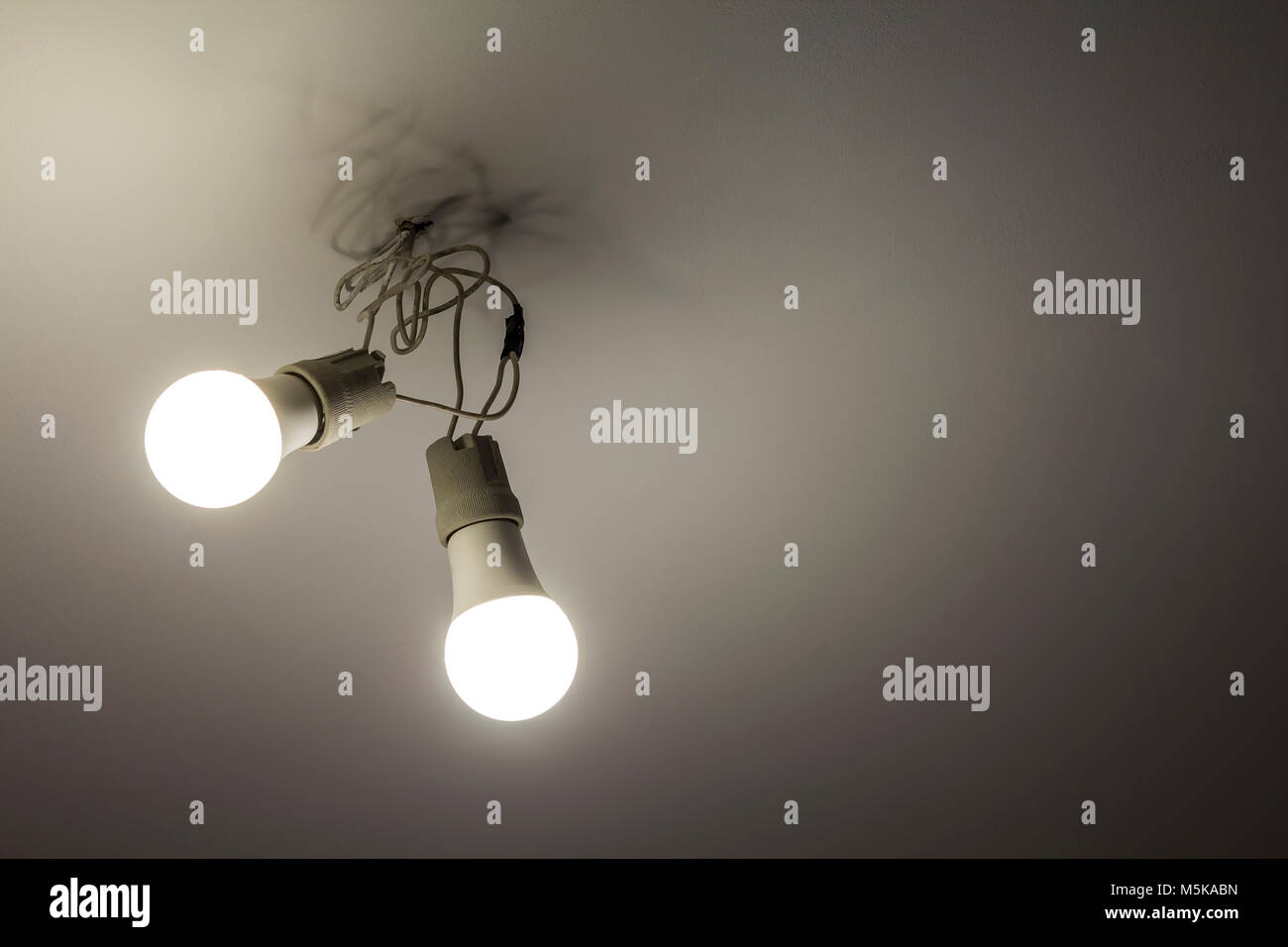 Light bulbs hang on ceiling hi-res stock photography and images - Alamy