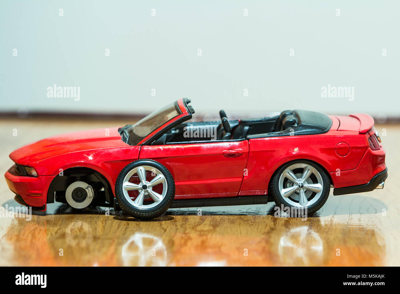Close-up of rear view of red toy car after road accident Stock Photo ...