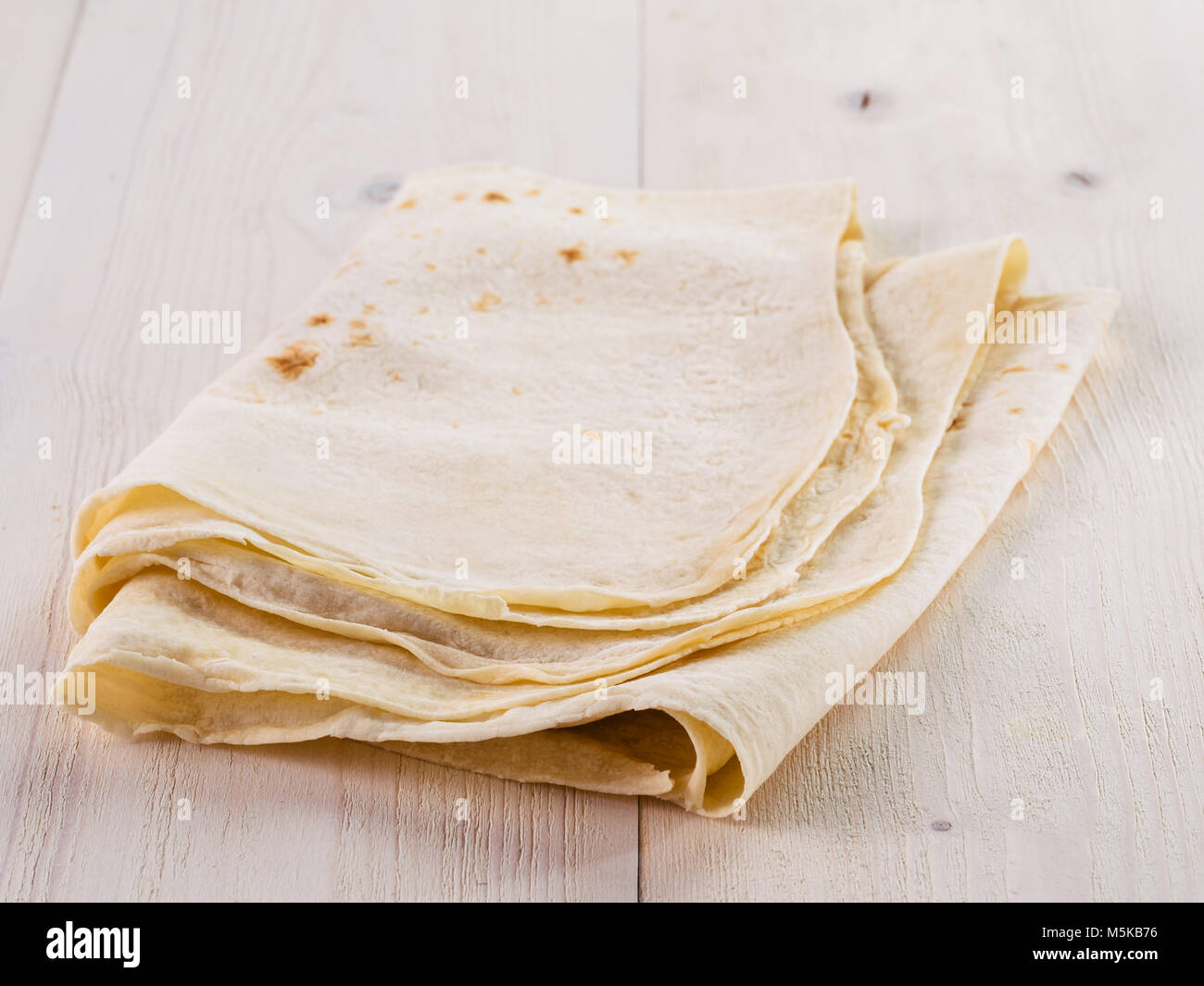 Armenian flat bread lavash. Pita bread on white wooden table. Copy ...