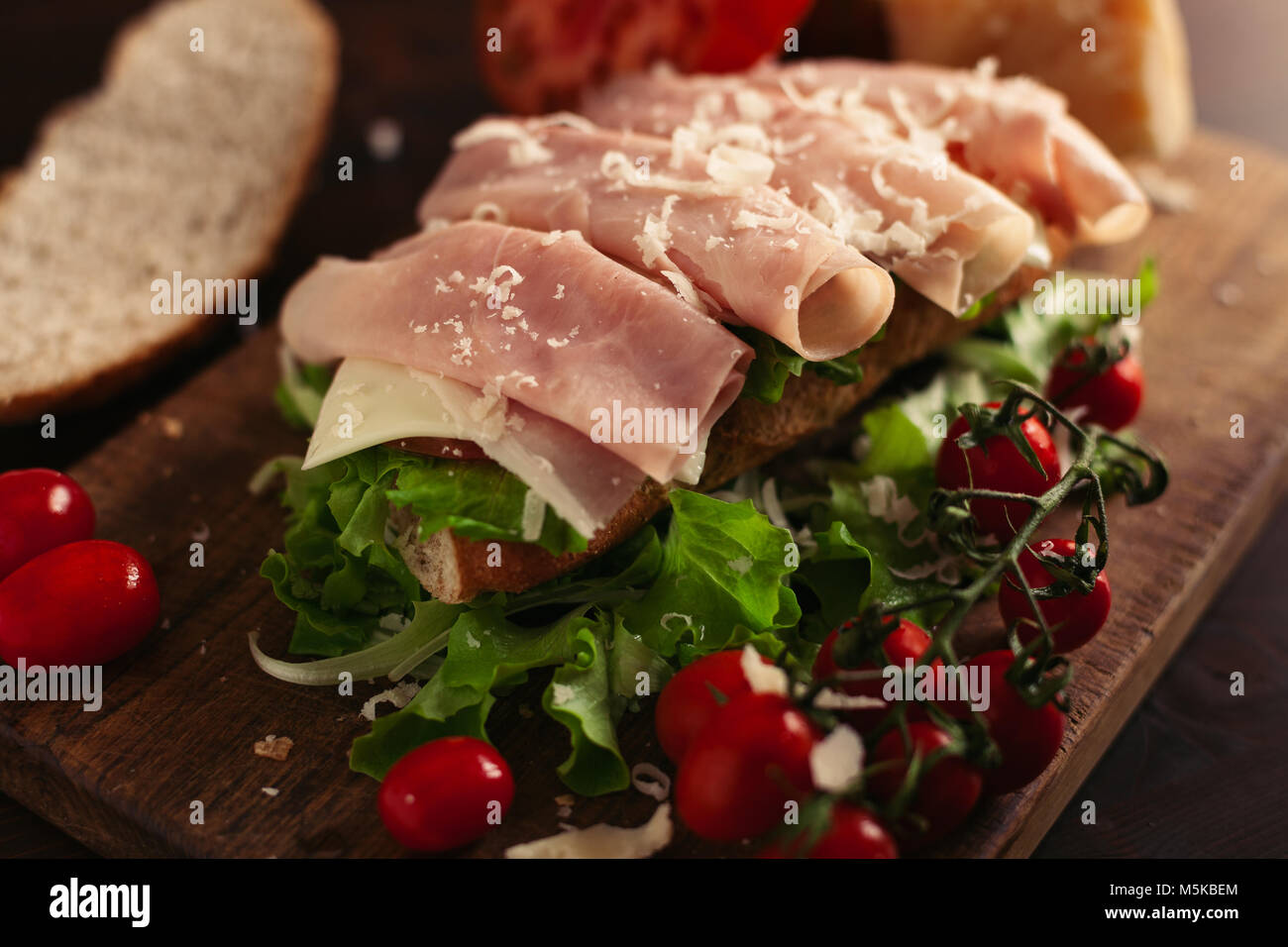 Traditional italian sandwich with cheese, ham, salad, tomatoes and ...