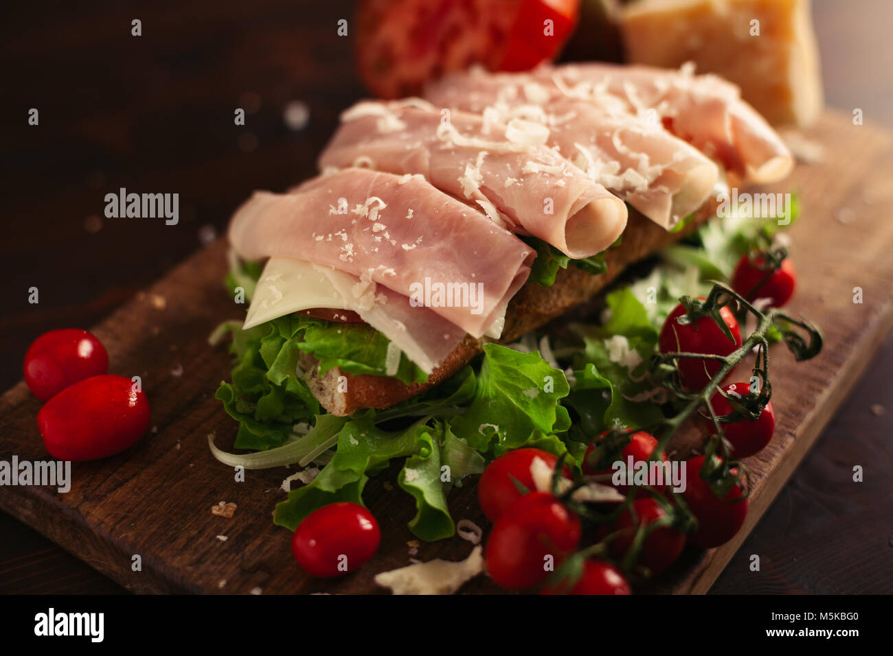 Traditional italian sandwich with cheese, ham, salad, tomatoes and ...