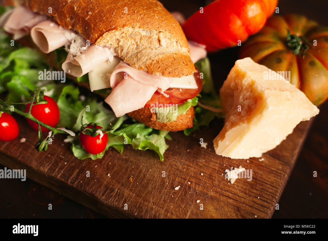 Traditional italian sandwich with cheese, ham, salad, tomatoes and ...