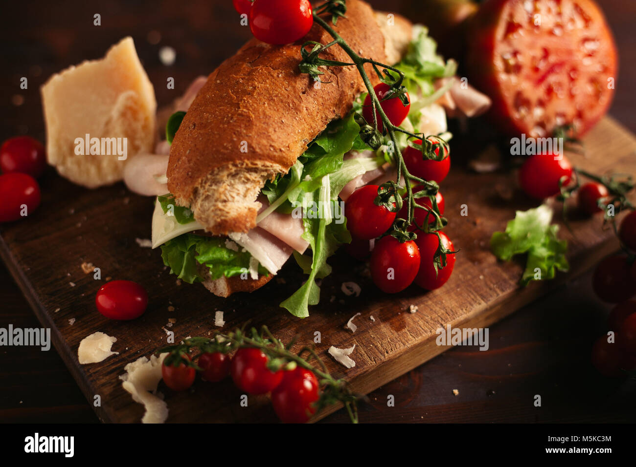 Traditional italian sandwich with cheese, ham, salad, tomatoes and ...