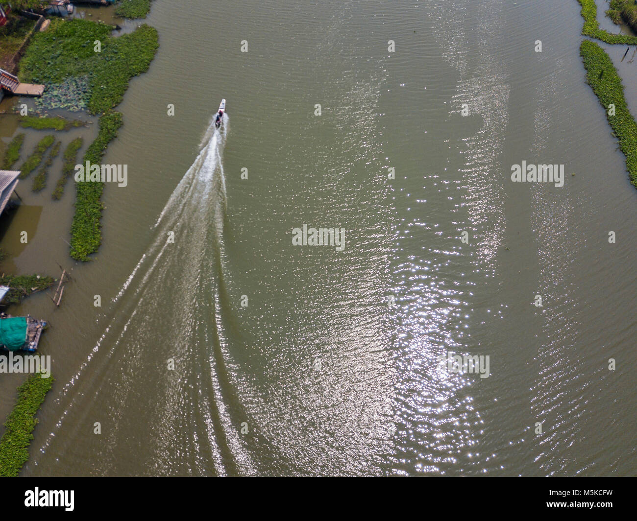 a long tail boat going up a river in Thailand, Southeast Asia Stock ...