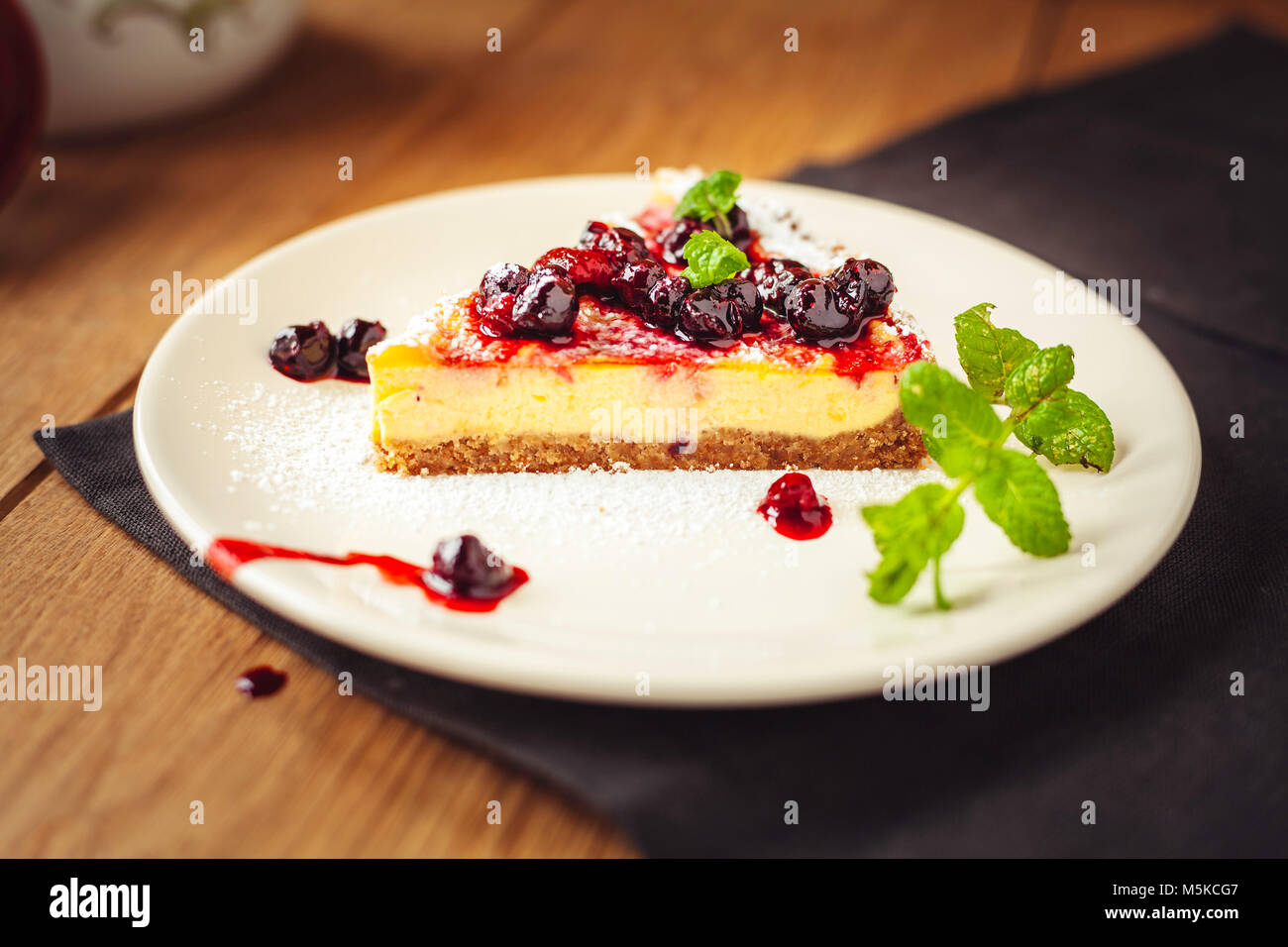 Beautiful traditional italian cheesecake with red fruits, mint, and ...