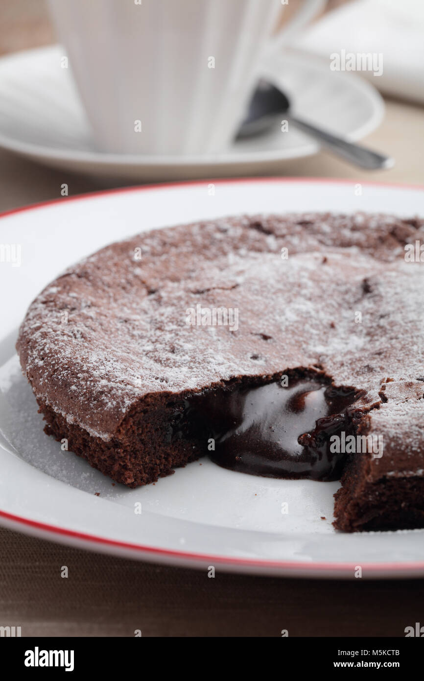 Chocolate cake with flowing chocolate on a plate Stock Photo - Alamy
