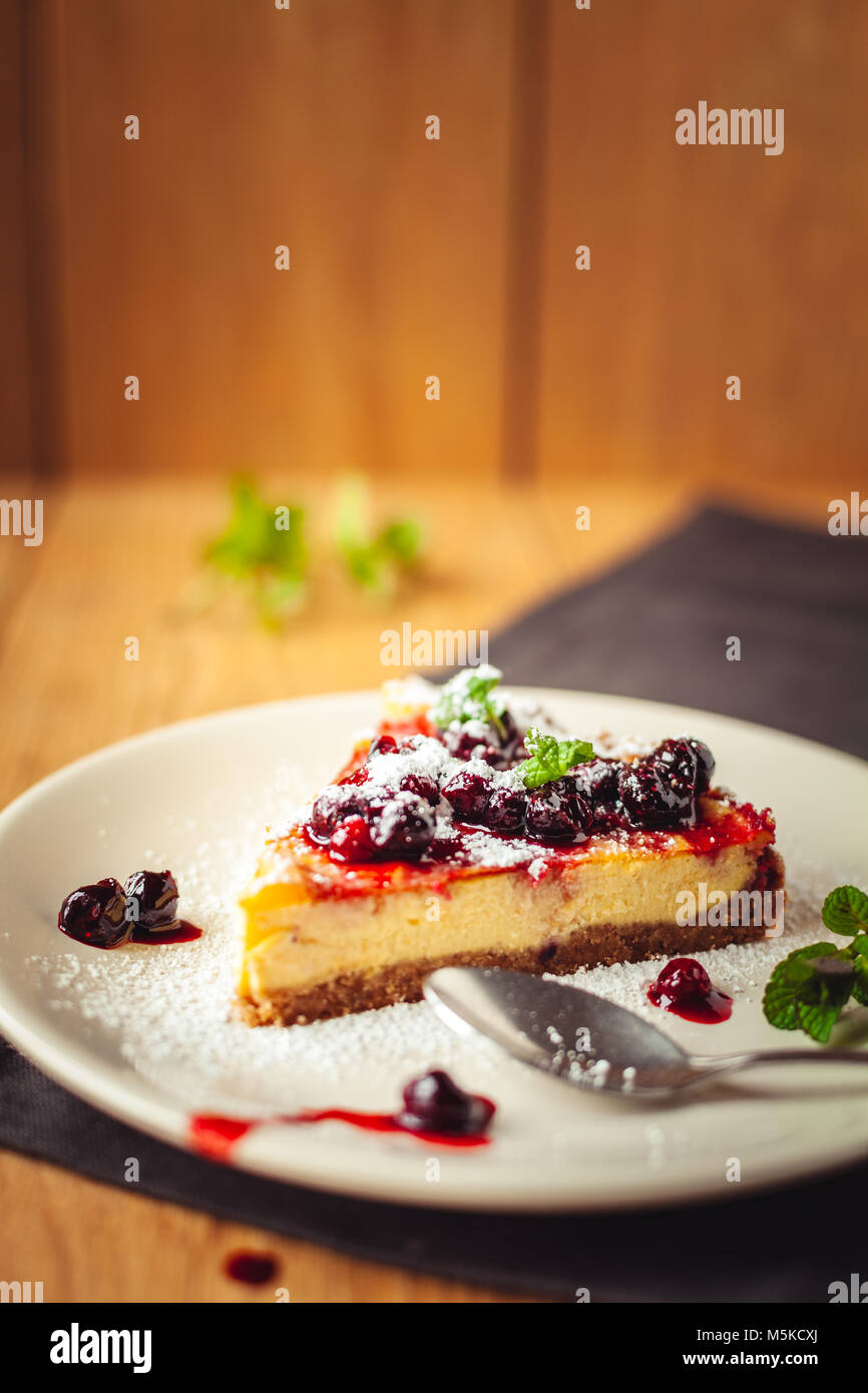 Beautiful traditional italian cheesecake with red fruits, mint, and ...