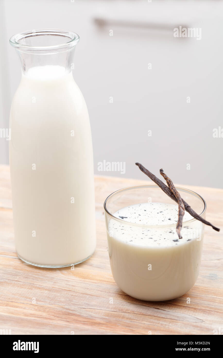 Vanilla milk on a kitchen table Stock Photo - Alamy