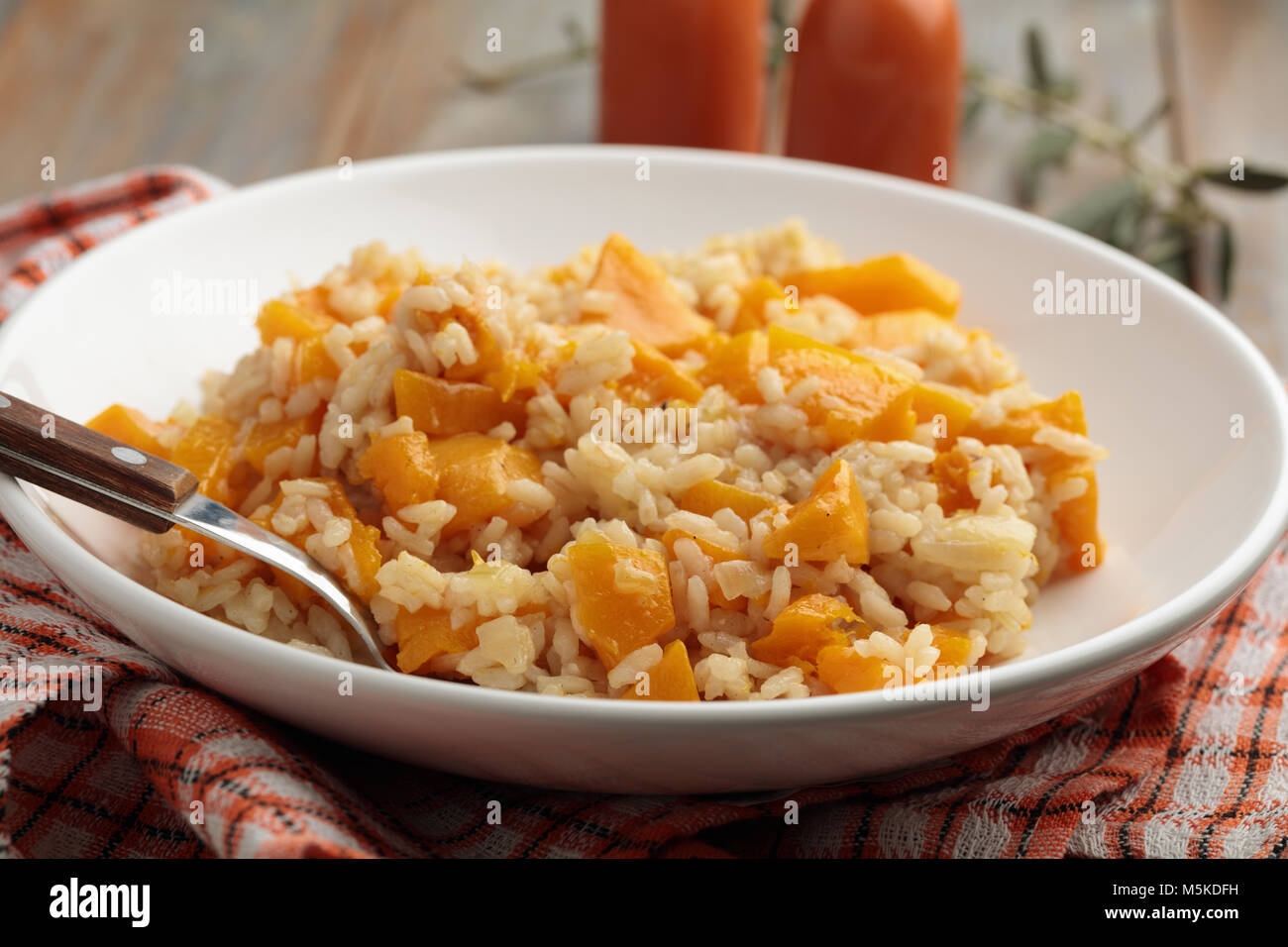 Pumpkin risotto on a rustic table Stock Photo - Alamy