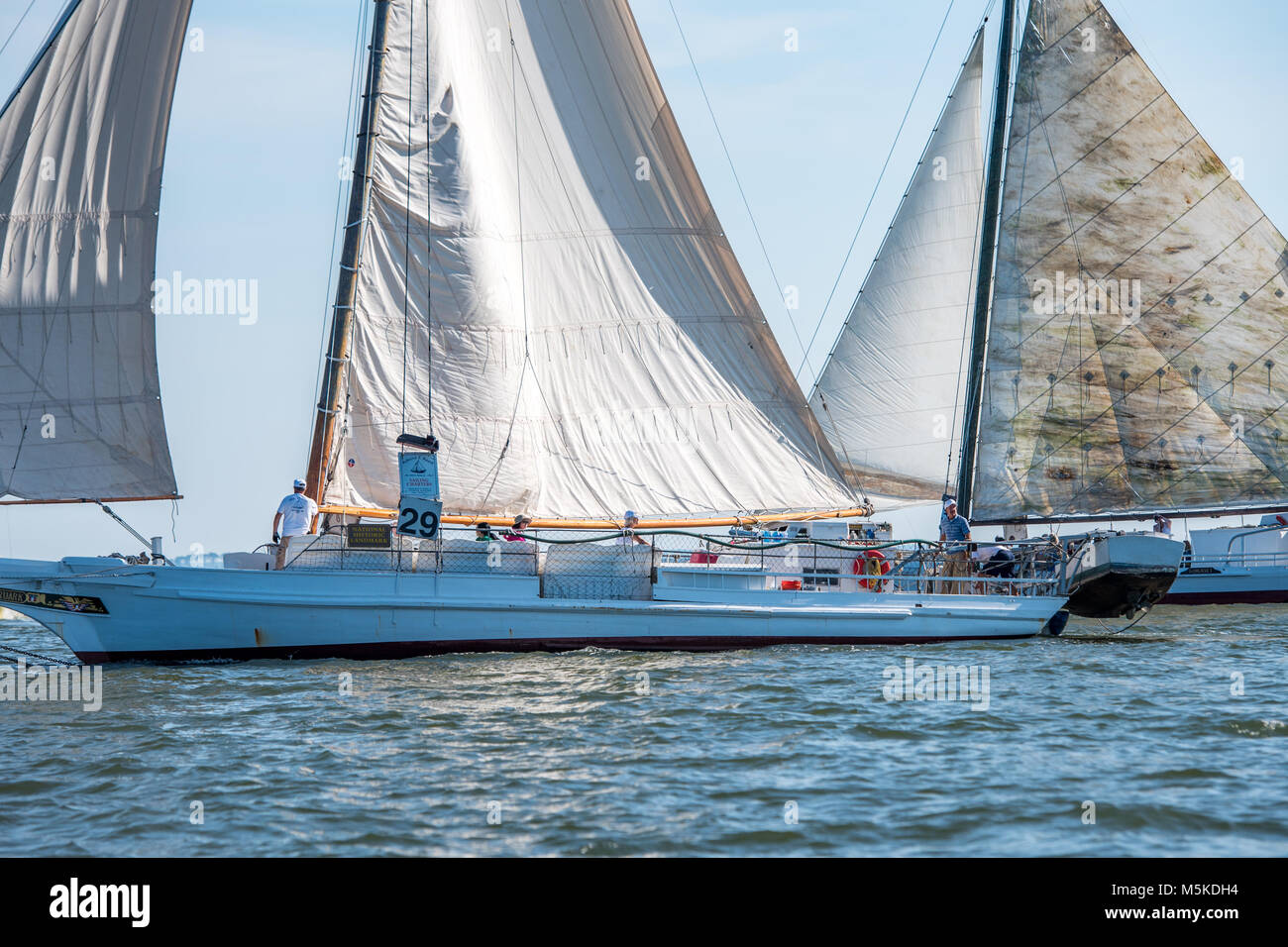 Two traditional skipjack boats crossing paths on the waters of the ...