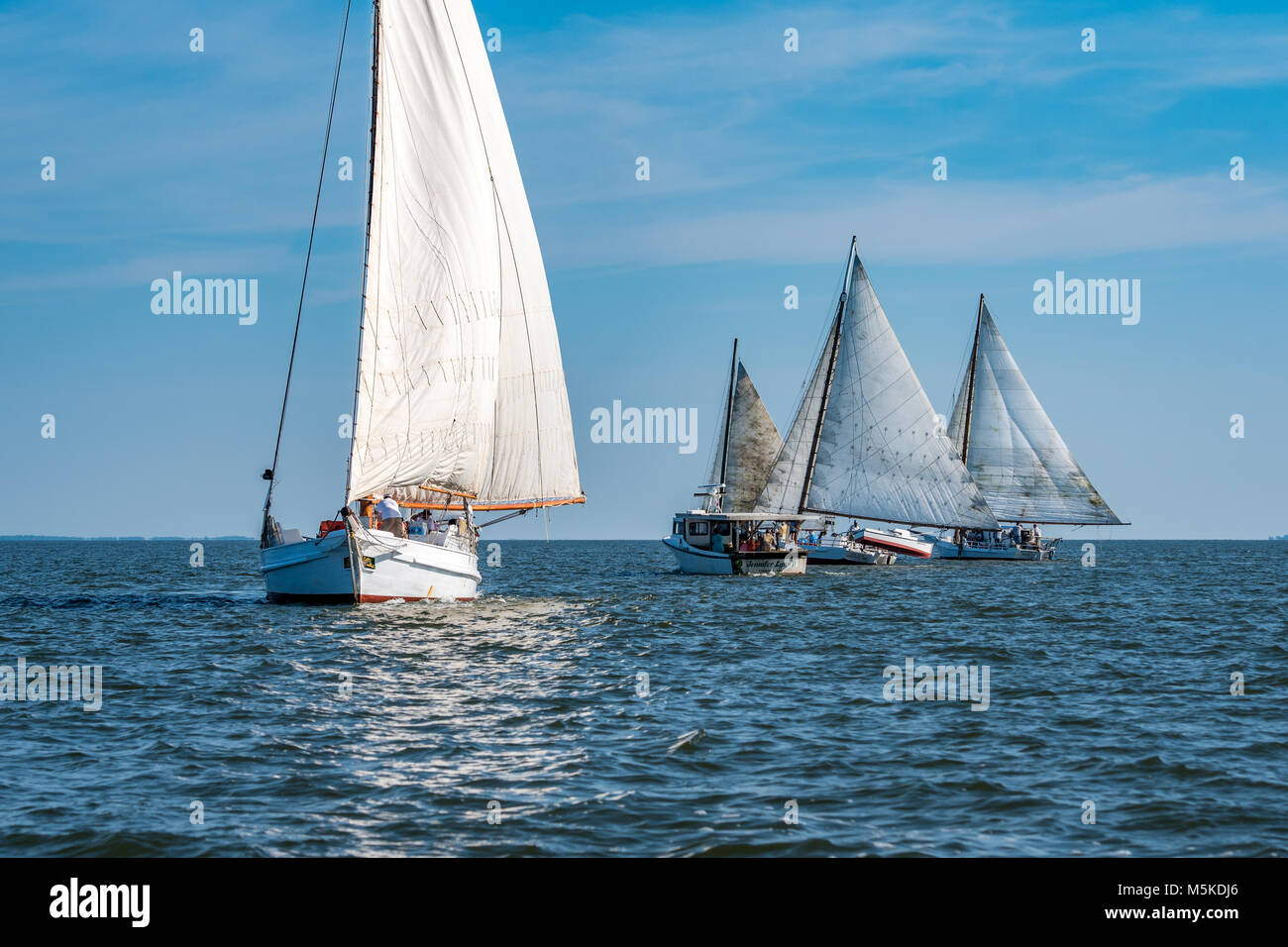 Traditional Skipjack boat cuts through Chesapeake Bay waters with other ...