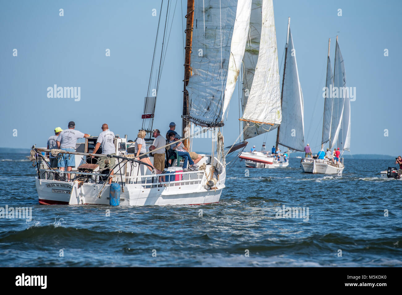 Group of people sailing on traditional Skipjack ship on the Chesapeake ...