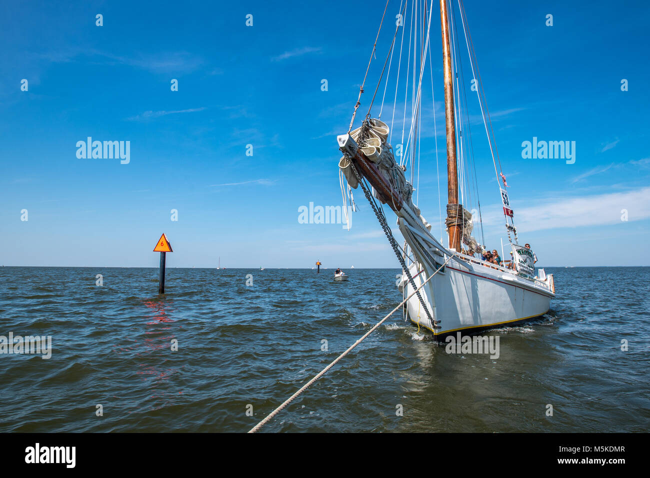 Rope attached to traditional Skipjack boat as it gets pulled along the ...