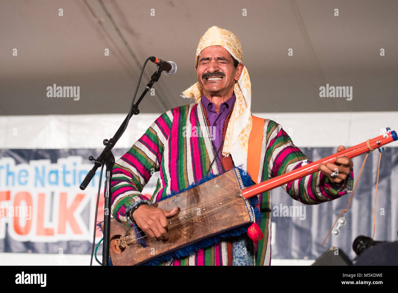 One member from musical group, Innov Gnawa, playing the Sintir on stage ...