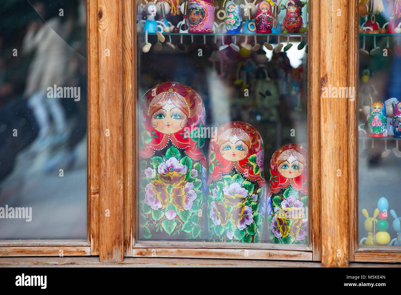 Three dolls of nested dolls behind the glass. Nested dolls Stock Photo ...