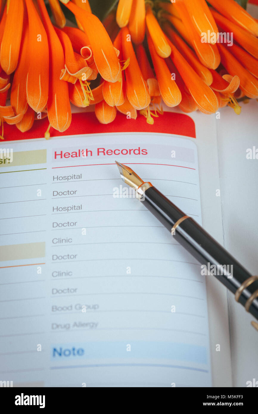 Health records in book note with fountain pen in color Stock Photo - Alamy