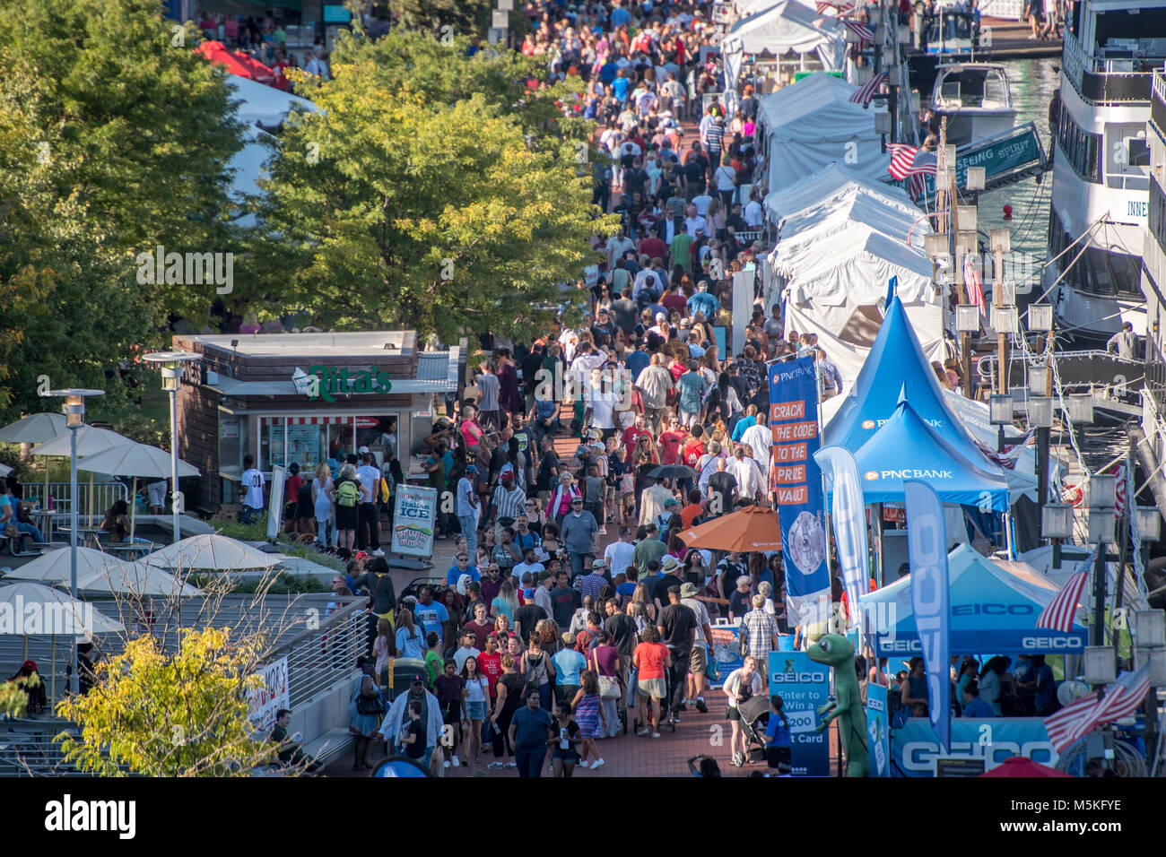 Street in Baltimore Inner Harbor crowded with people attending book ...