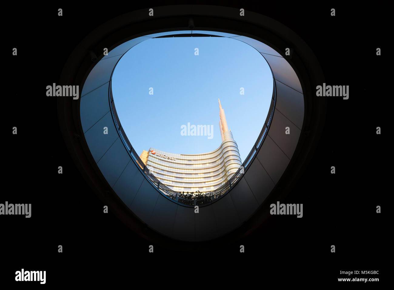 View of the Unicredit Tower spire from the Gae Aulenti square. Milan ...