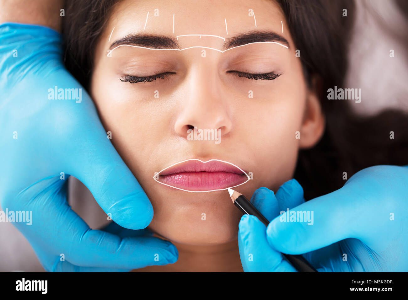 Cosmetologist Applying Permanent Make Up On Young Woman's Lips Stock ...