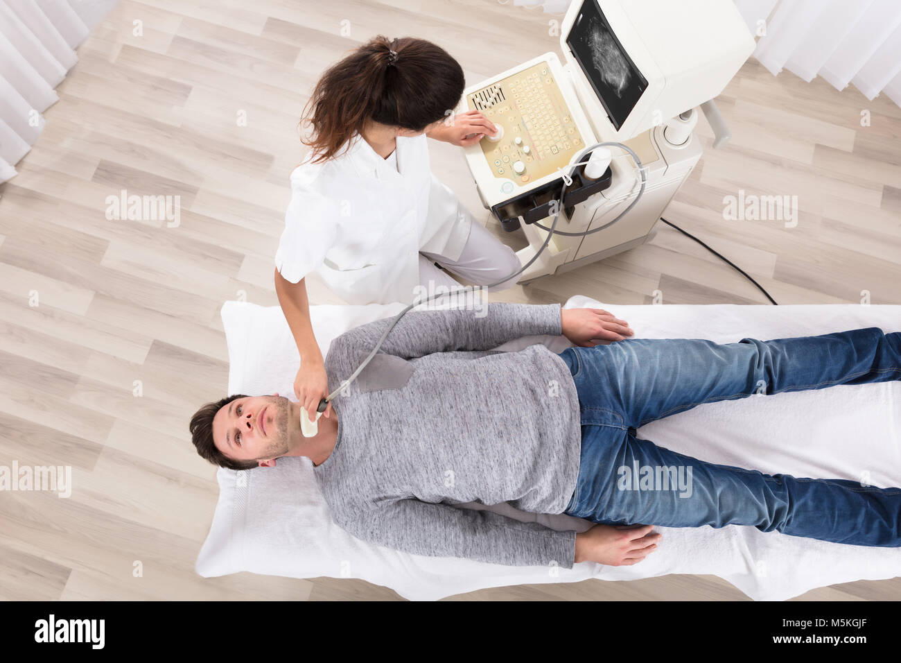 Man Undergoing The Medical Ultrasound Examination In Clinic Stock Photo ...