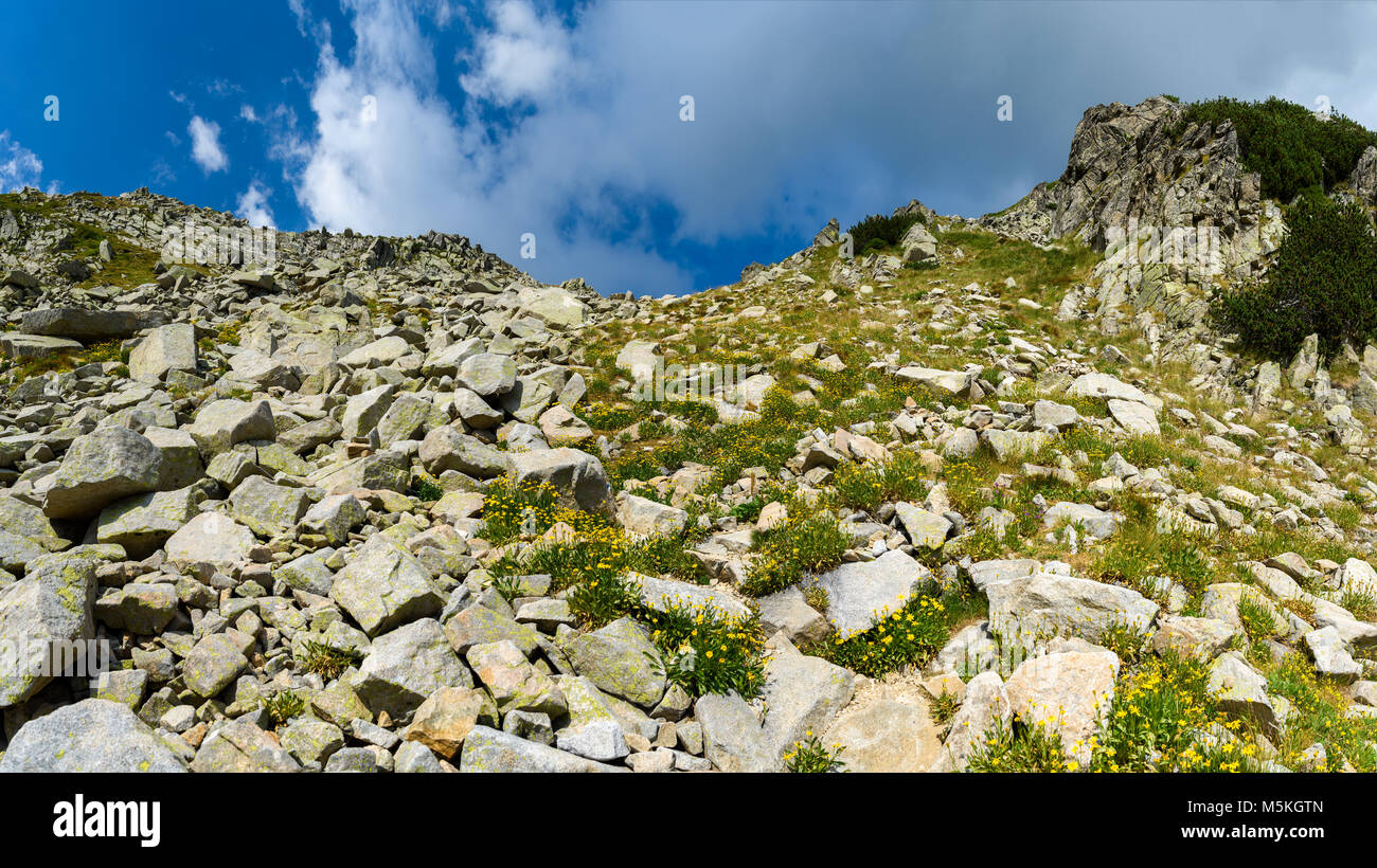 Difficult hiking trail going uphill through the rocks on steep mountain ...