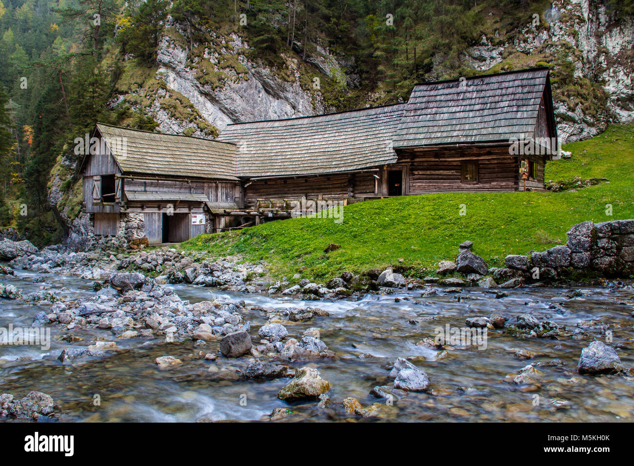 Working watermill with flowing water mountain stream in the village ...