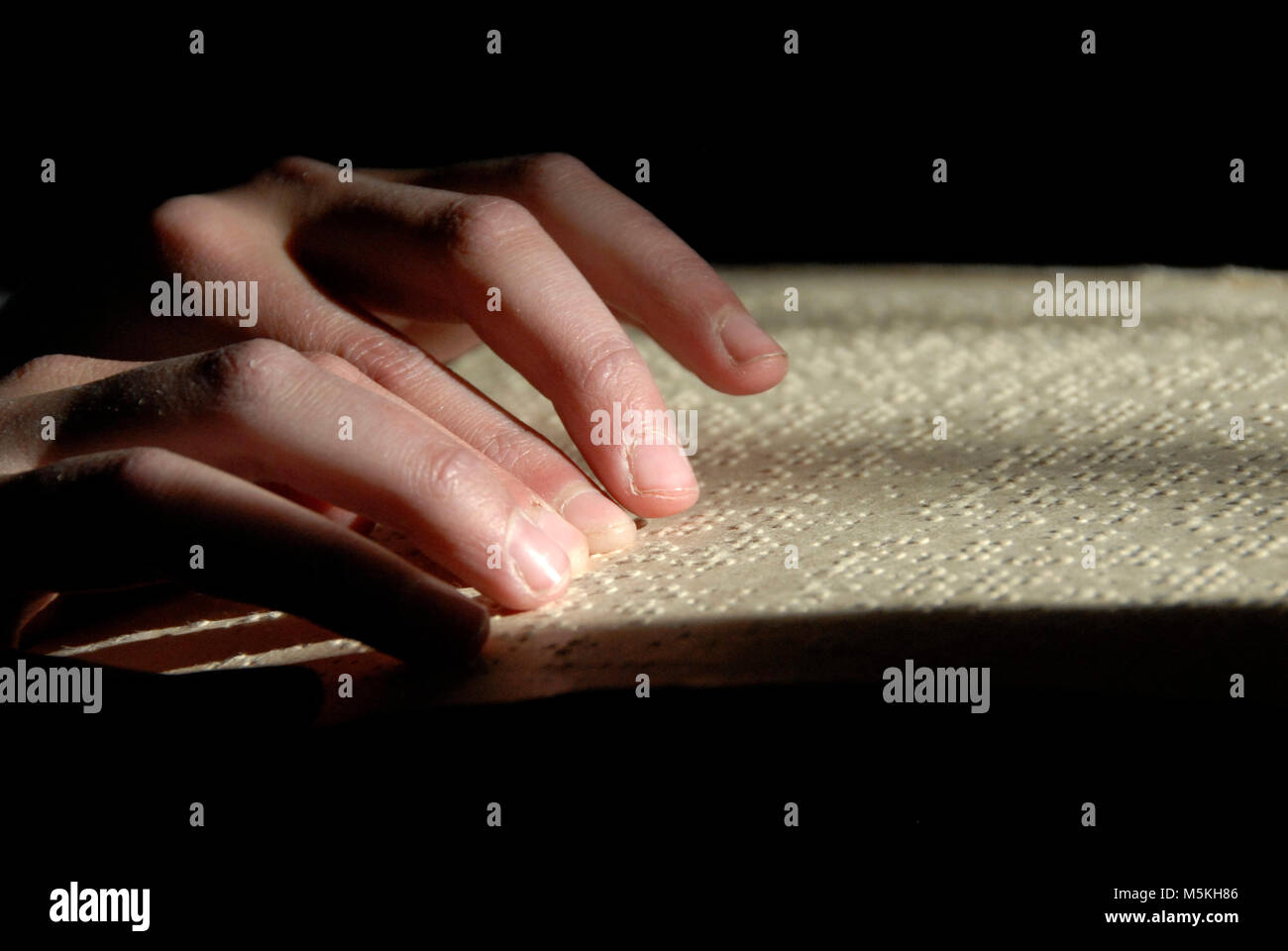 blind reading text in braille. close-up of human hands reading braille ...