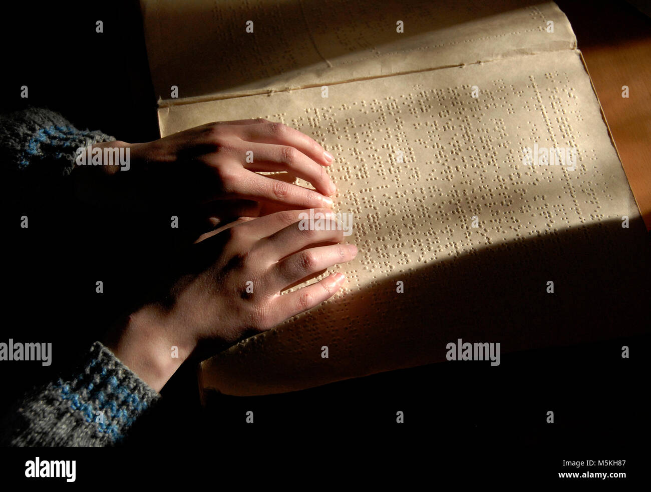 blind reading text in braille. close-up of human hands reading braille ...