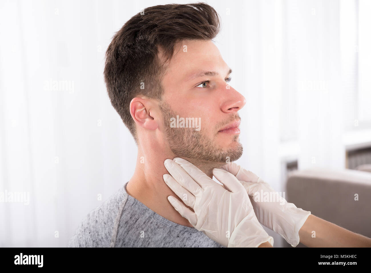 Doctor Performing Physical Exam Palpation Of The Thyroid Gland Stock ...