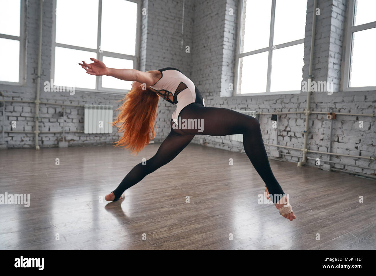 Young beautiful dancer posing on a studio background Stock Photo - Alamy