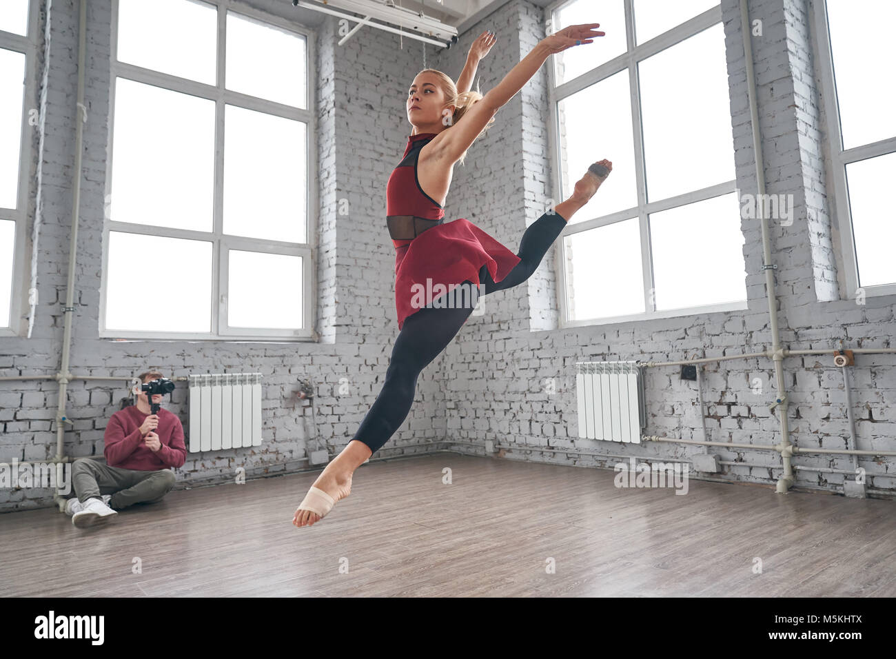 Young female dancer jumping and dancing in the gym Stock Photo - Alamy
