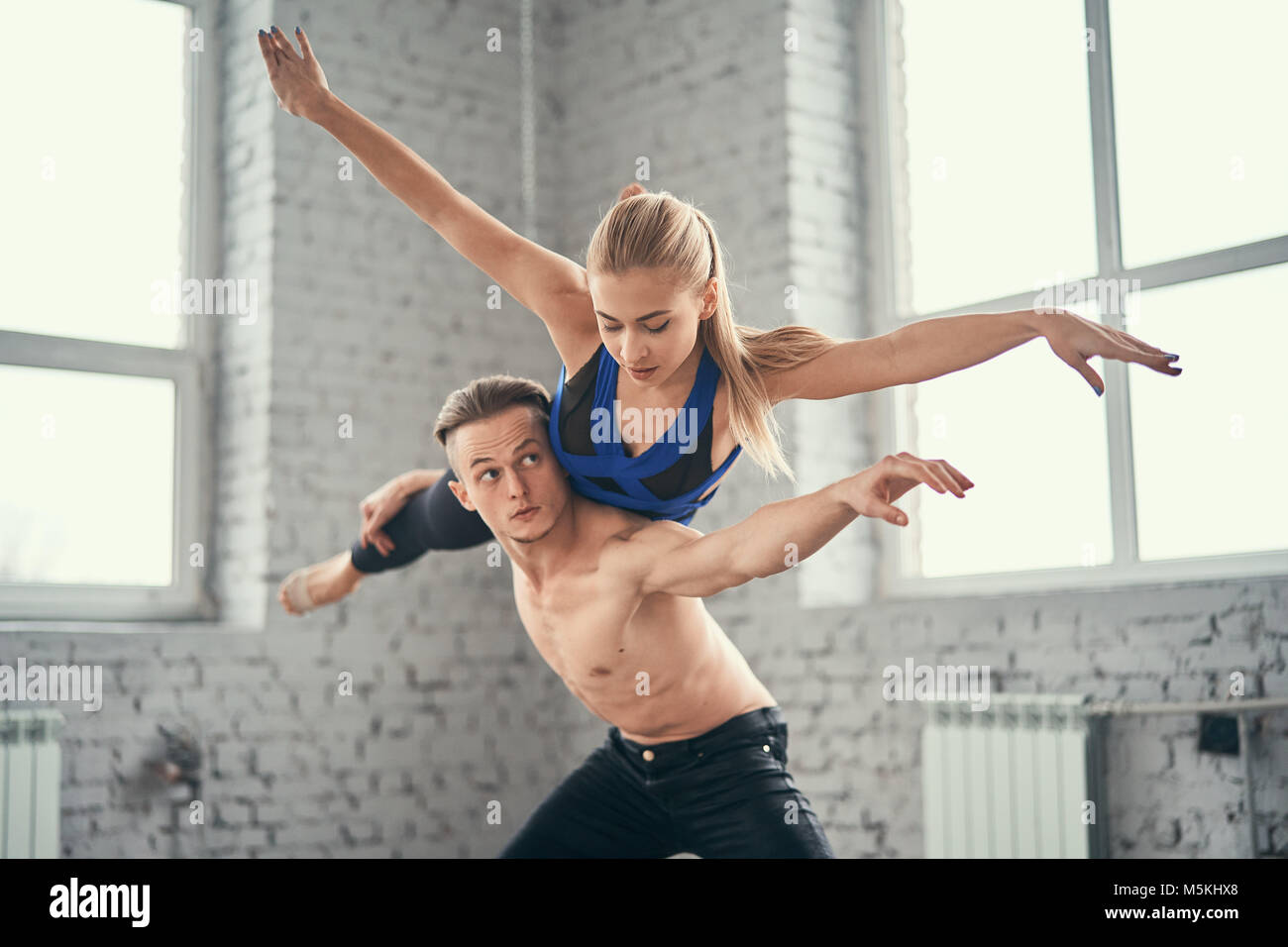 A young couple of dancers perform complex tricks Stock Photo - Alamy