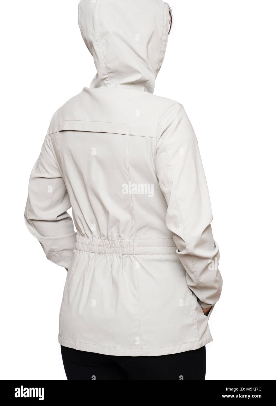 Young woman wearing beige rain jacket isolated on white background ...