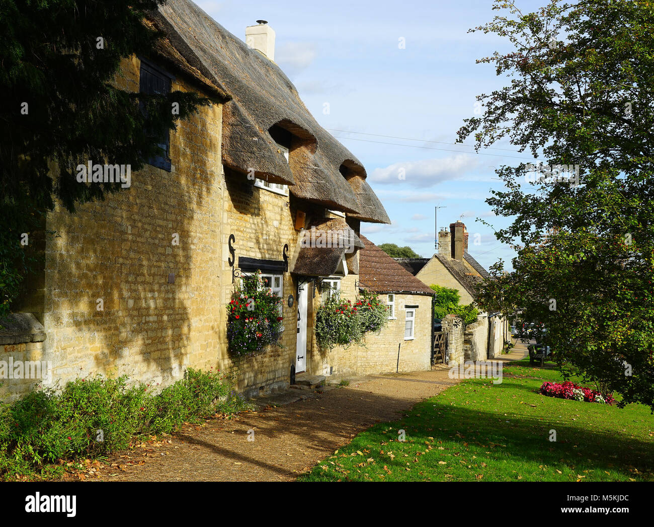 Pretty stone cottages in Church Street, Nassington Stock Photo - Alamy