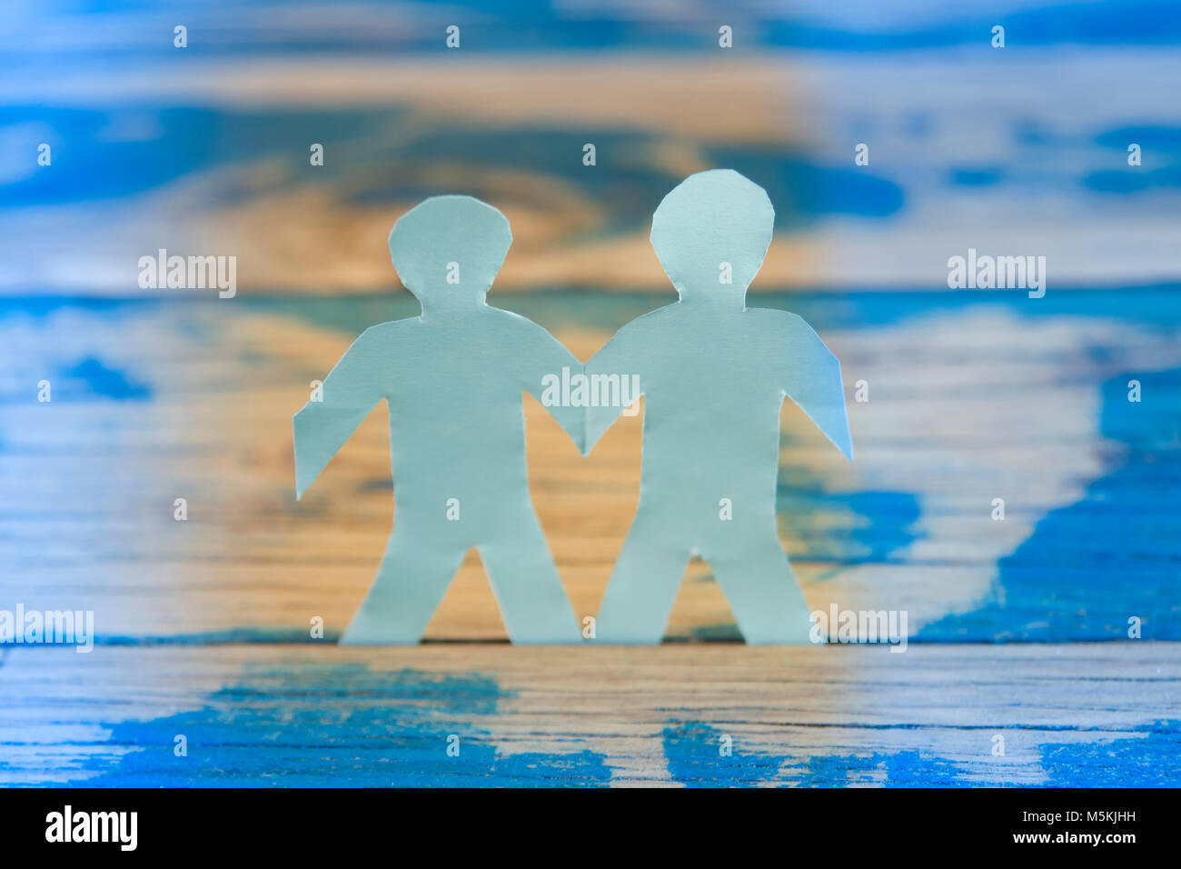 blue paper people on wooden background Stock Photo - Alamy