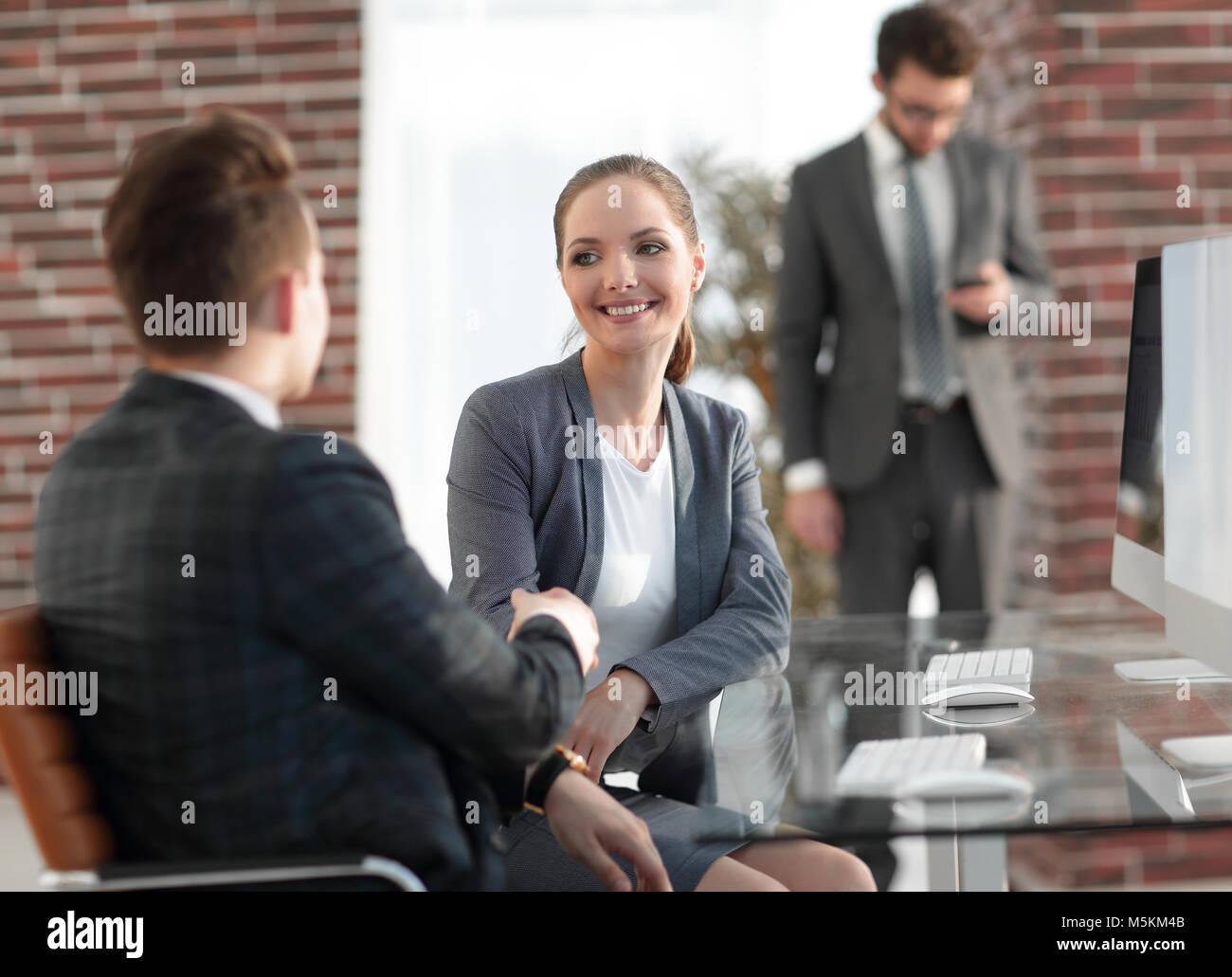 handshake Manager and the client in the office Stock Photo - Alamy