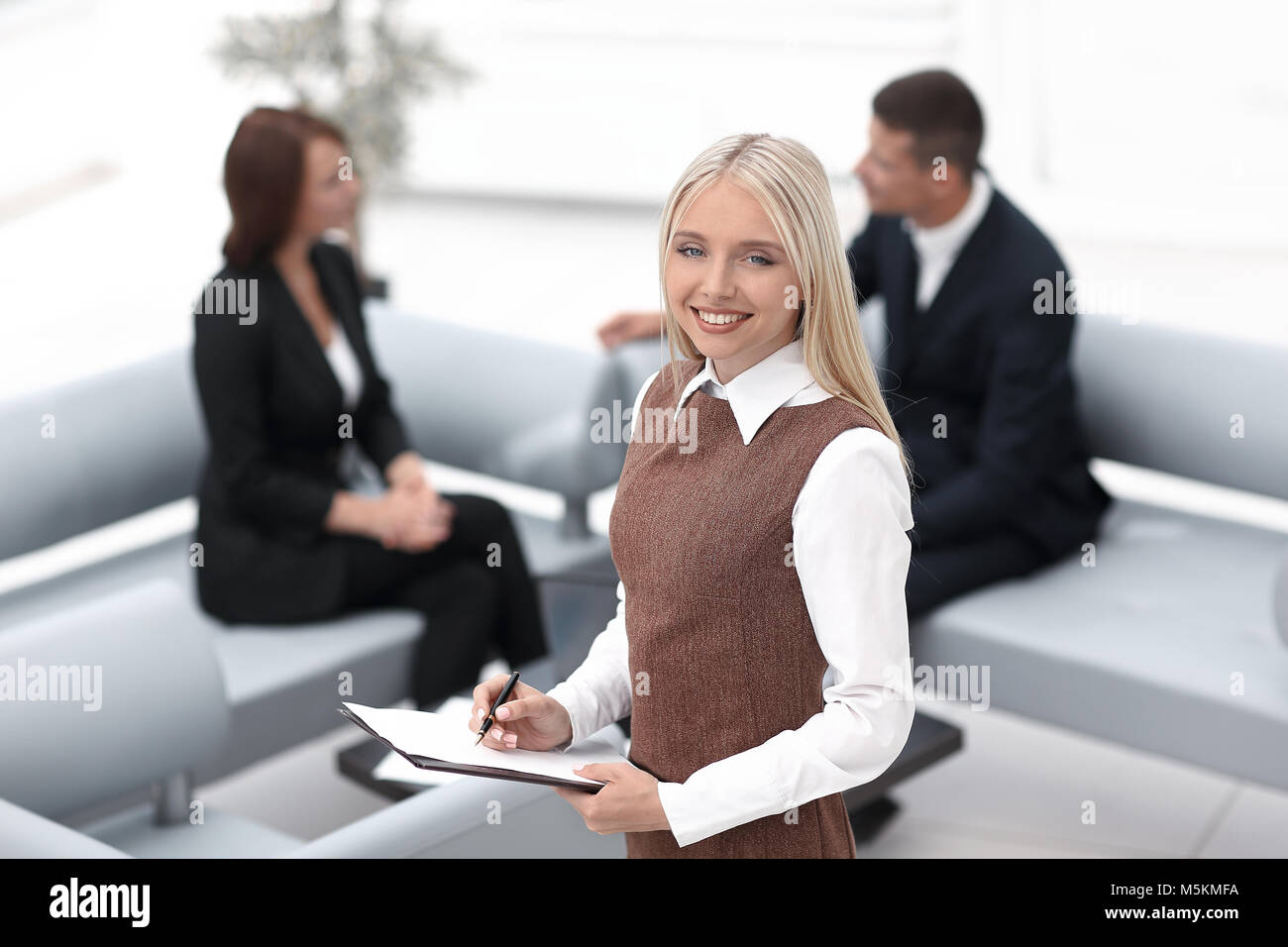 young woman assistant standing in the lobby of the modern office Stock ...