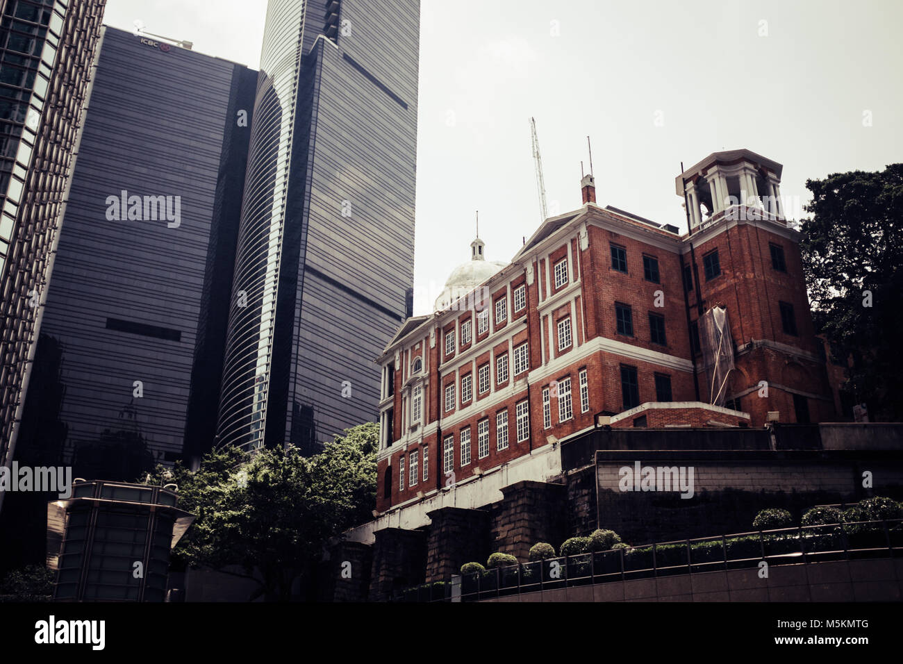 An old historic building next the a new tall modern skyscraper in Hong ...