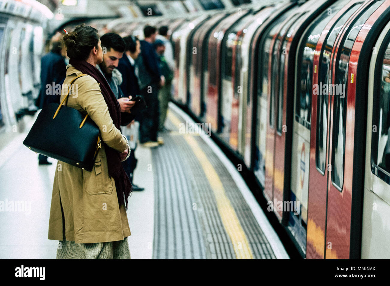 Commuters wait for the Central Line underground train in Bank Station ...