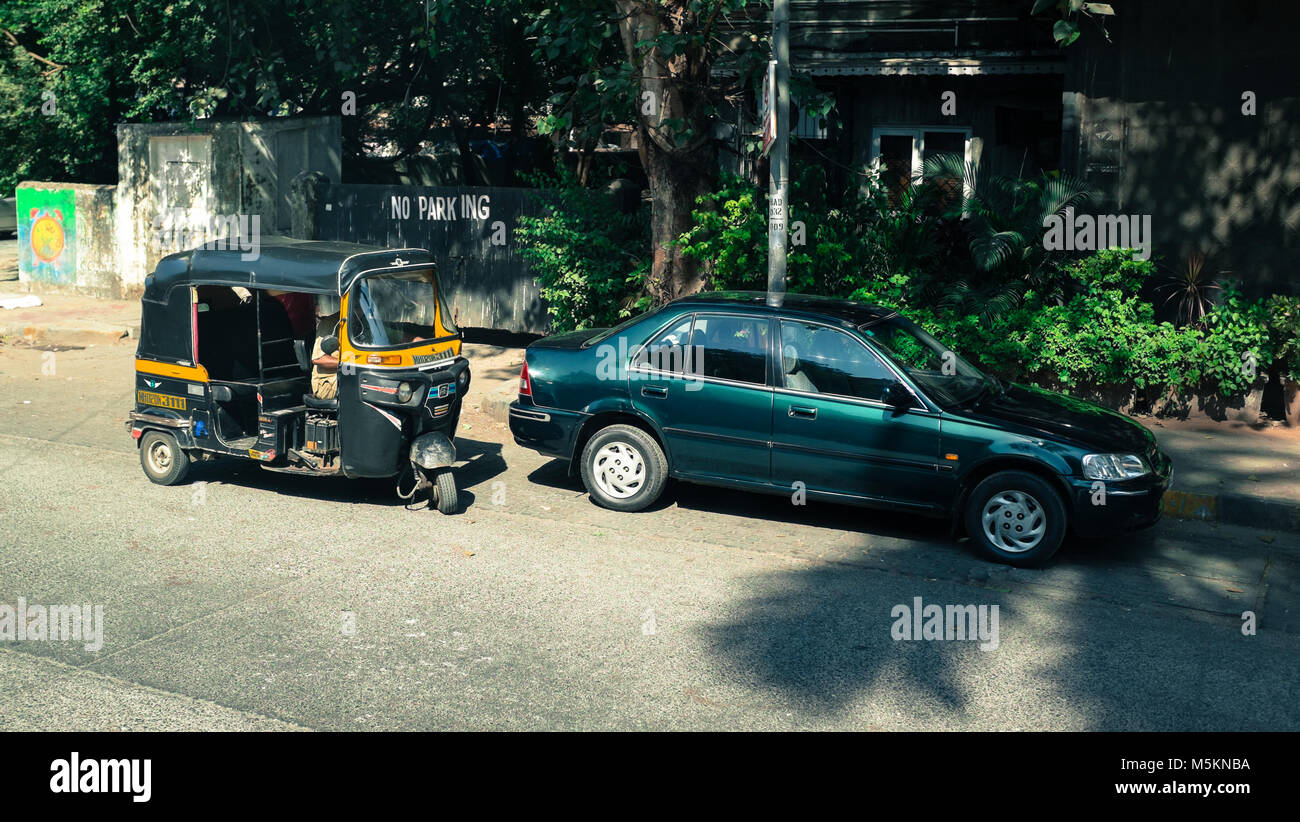 A tuk tuk and a normal taxi drive past in Mumbai, India Stock Photo - Alamy