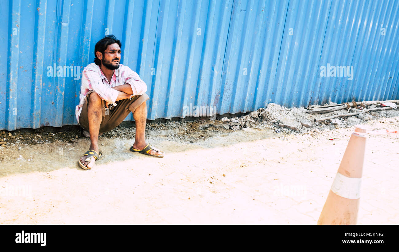 A man sitting by a shipping container in Mumbai, India Stock Photo - Alamy